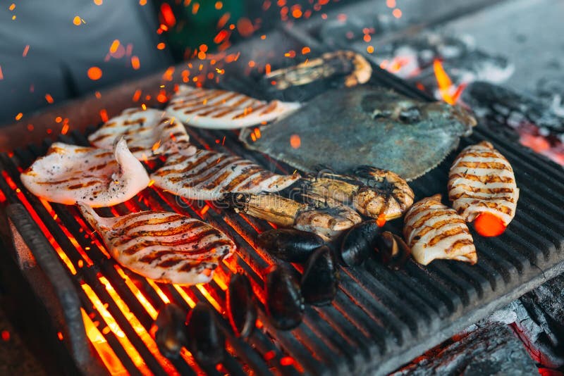 Seafood on the Grill. Mussels, Shrimp, Squid and Fish are Cooked on ...