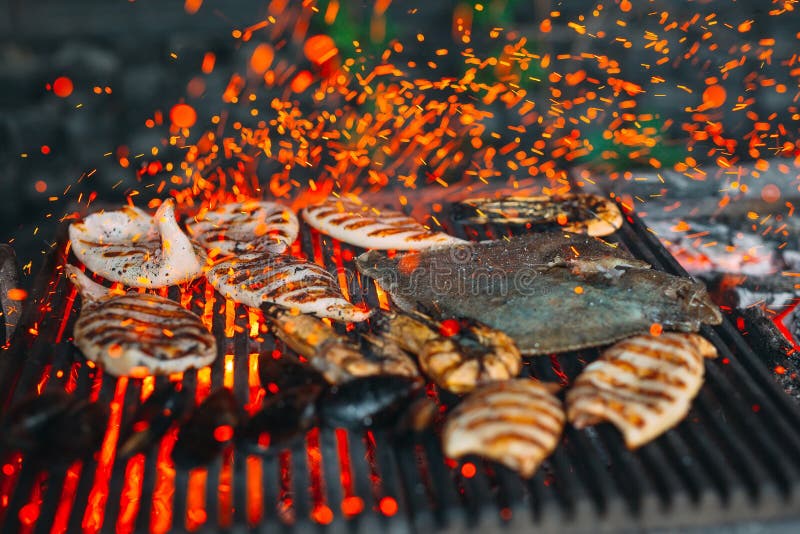 Seafood on the Grill. Mussels, Shrimp, Squid and Fish are Cooked on ...