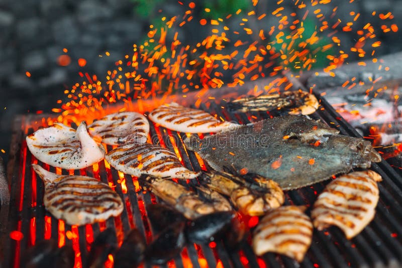 Seafood on the Grill. Mussels, Shrimp, Squid and Fish are Cooked on ...