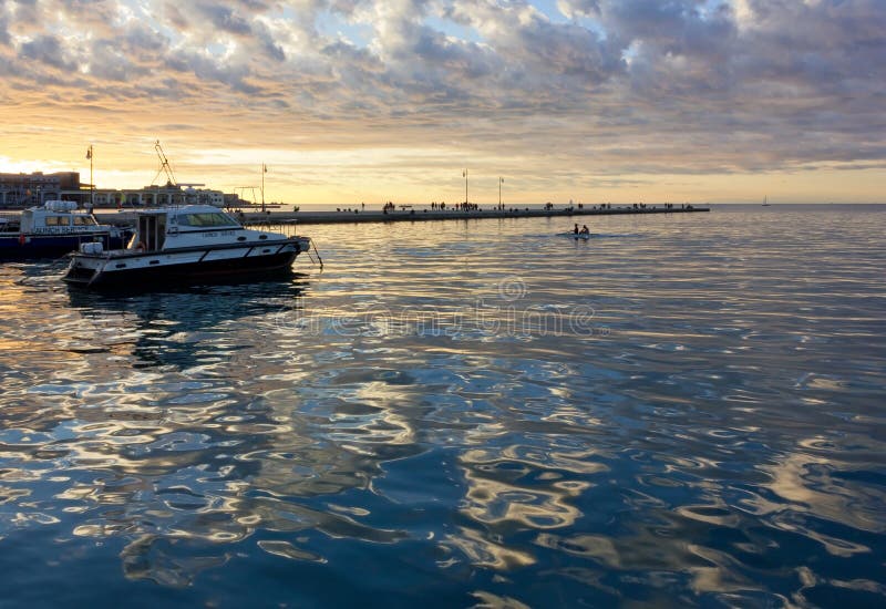 Trieste Seafront at Sunset stock photo. Image of canoe - 103326532