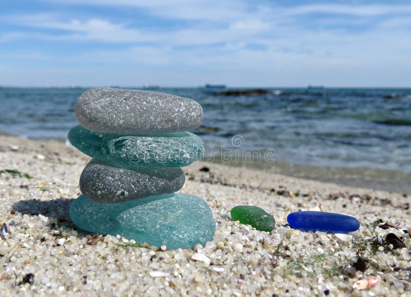 Seaglass Stack on Beach Sand with Seascape Background. Beachcombing ...