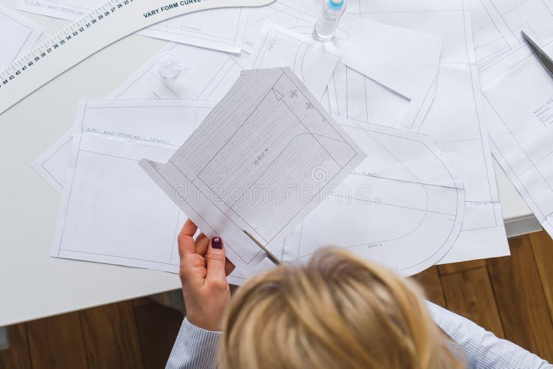Seamstress Cuts Papper Patterns for Dress with Scissors. Design ...