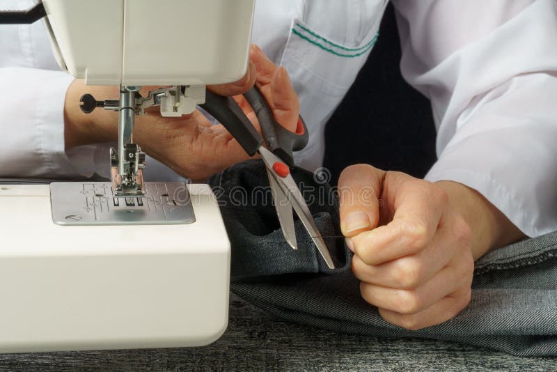 The Seamstress Cuts the Thread. the Process of Cutting and Sewing ...