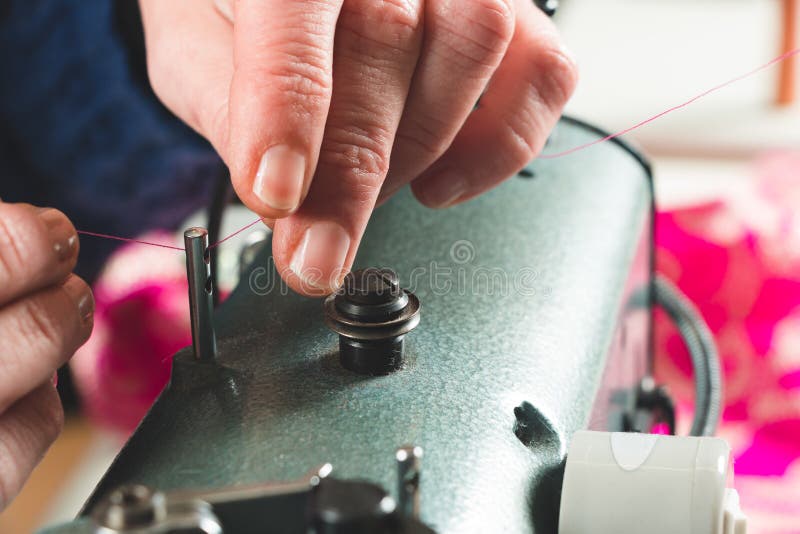 Seamstress Hands Placing Thread in Sewing Machine Stock Photo - Image ...