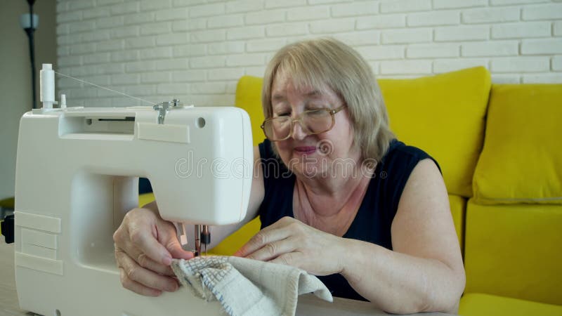 Seamstress Sewing Fabric with Sewing Machine at Home Stock Footage ...