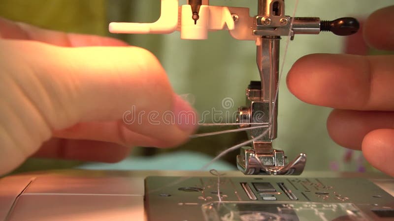 A Seamstress is Threading the Eye of a Needle with a Needle Threader ...