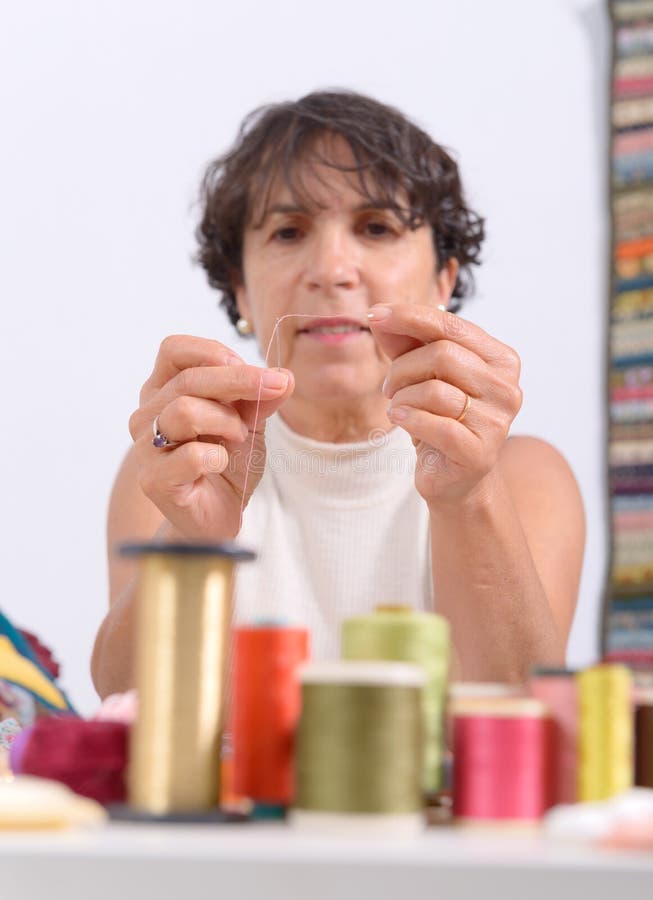 Seamstress Threading a Needle Stock Image - Image of finger, needle ...