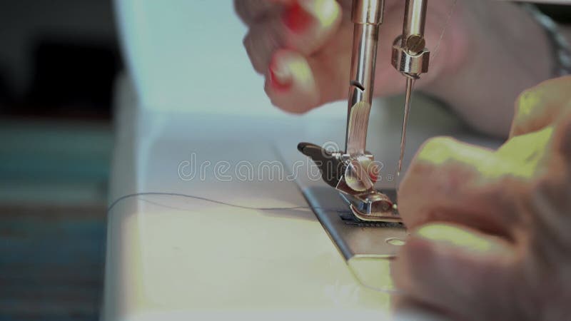 Hands of an Elderly Woman Threading the Needle of the Sewing Machine ...