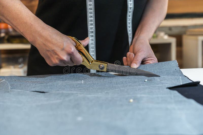 Seamstress Using Scissors To Cut Textile at Work Table Stock Photo ...