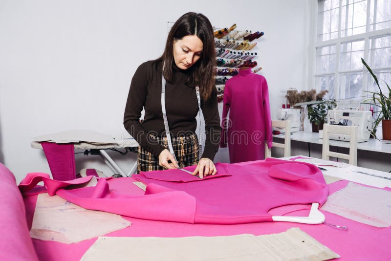 Seamstress Working with Sewing Pattern on Table in Tailor Shop Stock ...