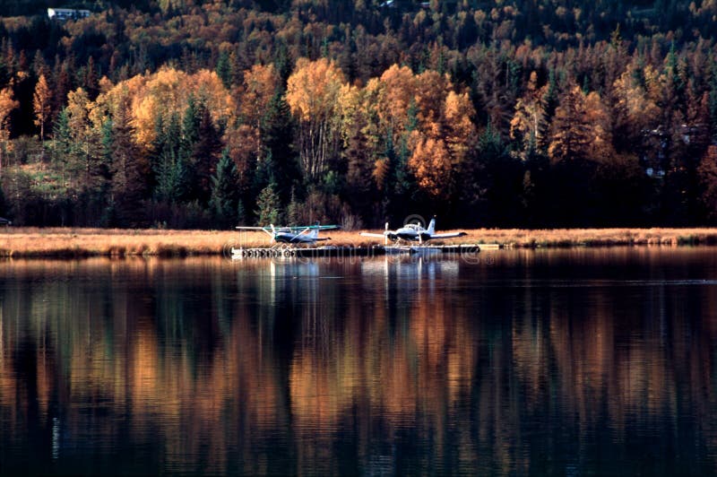 Alaska Float Plane Moored at Dock Amid Foliage Reflections Stock Image ...