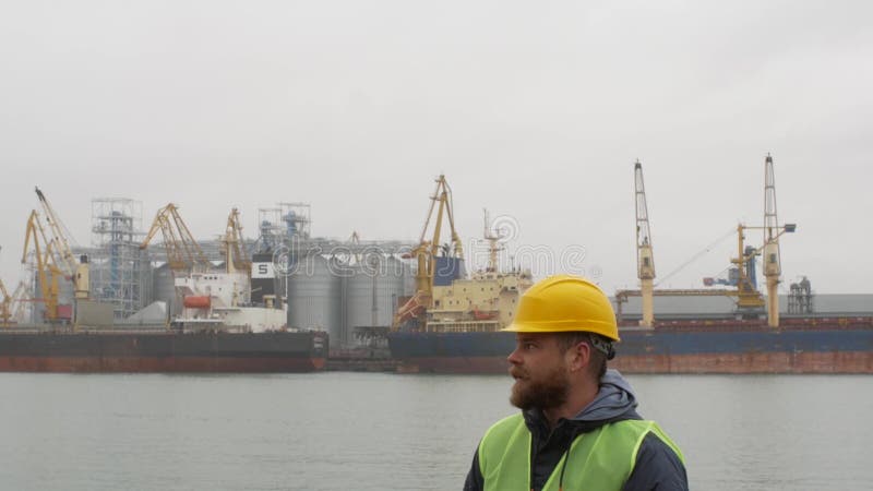 Seaport Worker with a Beard and a Helmet on the Background of Ships ...