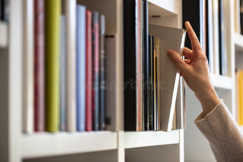 Searching for a book stock image. Image of information - 209910821