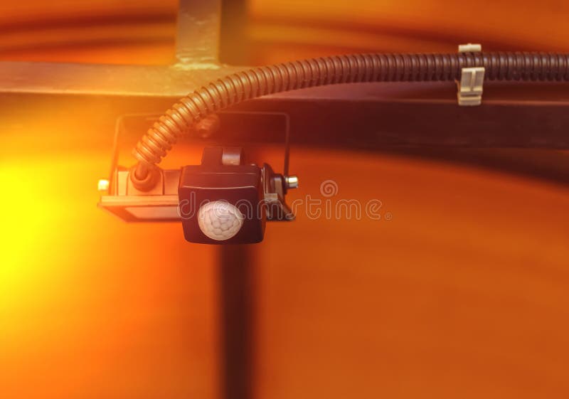 A Searchlight with a Motion Sensor on a Metal Roof for Lighting the ...