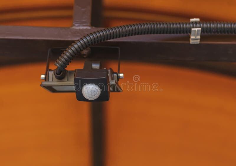 A Searchlight with a Motion Sensor on a Metal Roof for Lighting the ...