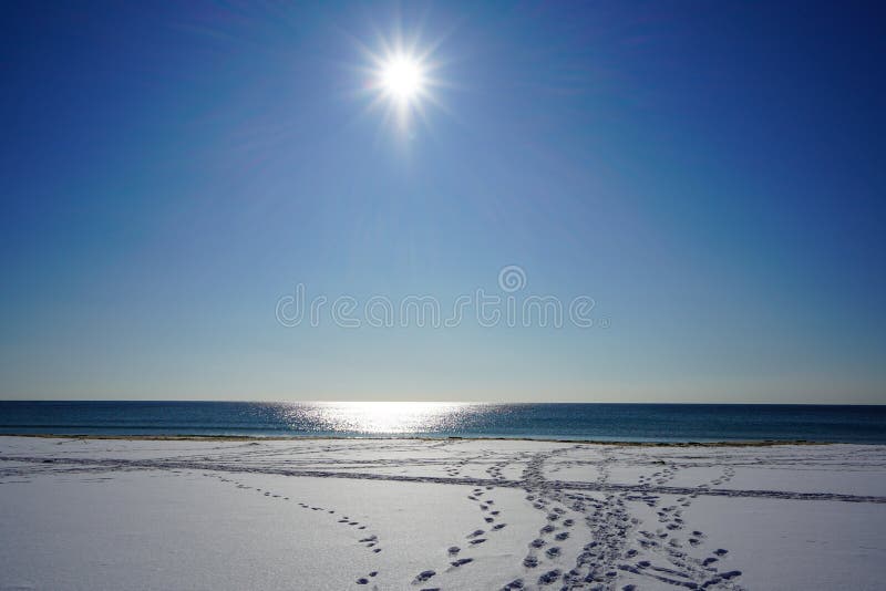 Seascape with a Beach in Snow and Bright Sun Stock Photo - Image of ...