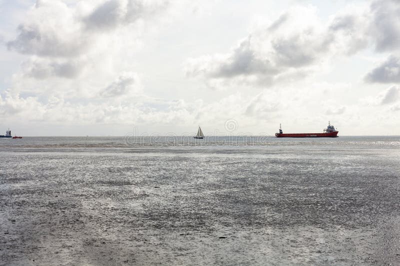 Seascape with Cargo Ships in the Distance and Cloudy Sky Stock Image ...