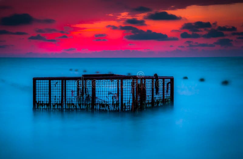 Seascape and Empty Cage at Colorful Sunset Stock Photo - Image of milky ...