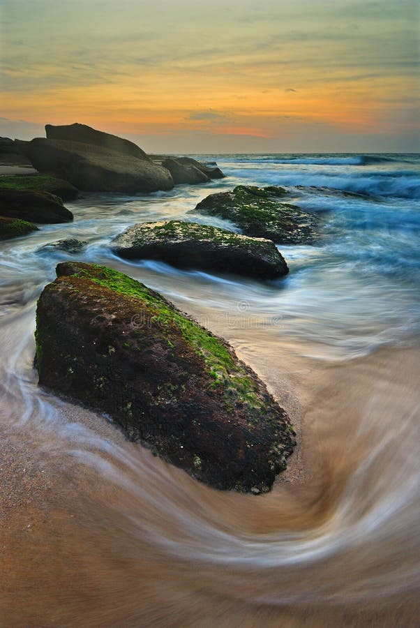 Seascape Sunrise Flowing Waves Stock Photo - Image of sunrise, stone ...