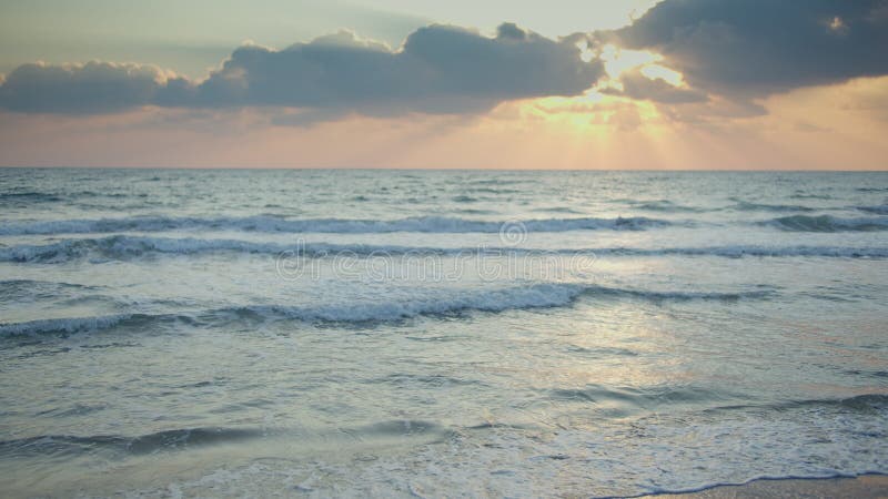 A Seascape at Sunset. Rays of the Sun Break through the Clouds Stock ...