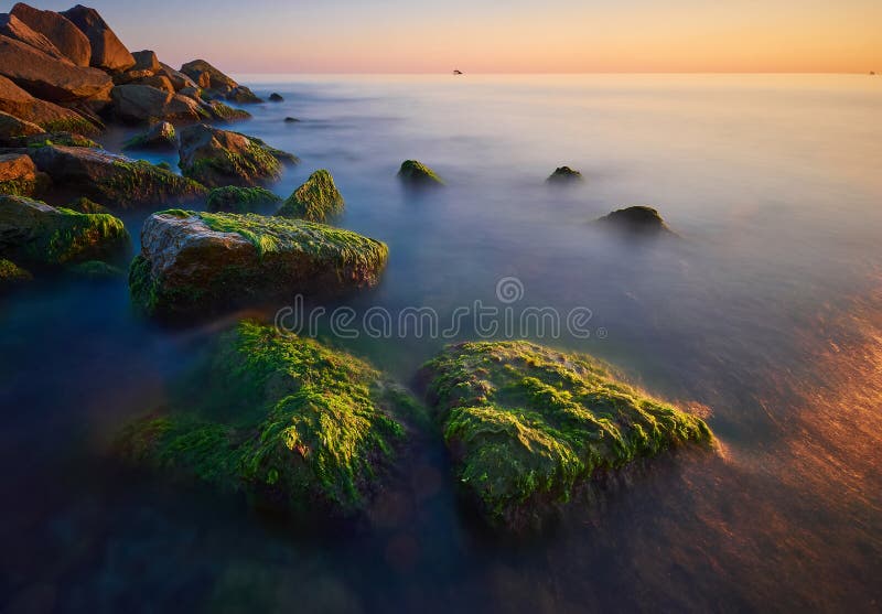 Seascape at Sunset. Sea on a Long Shutter with Stones Stock Photo ...