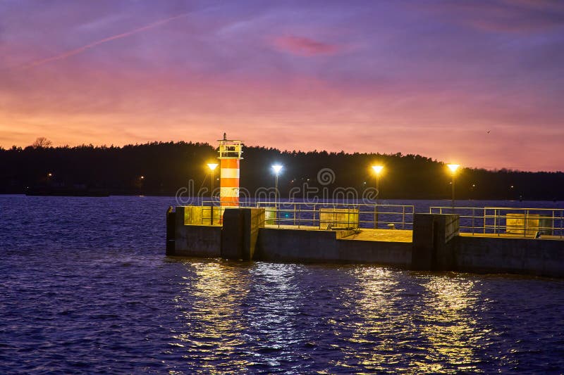 A Small Red Lighthouse on the Edge of the Island Against the Background ...
