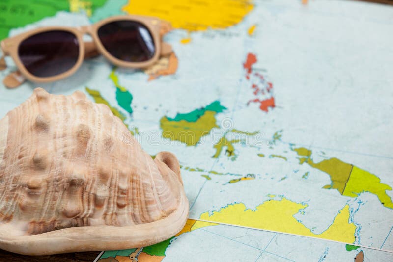 Seashell and Sunglasses on World Map Stock Photo - Image of morning ...
