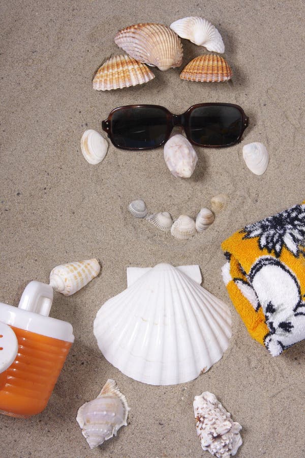 Seashells face in the sand stock photo. Image of vacation - 9998452