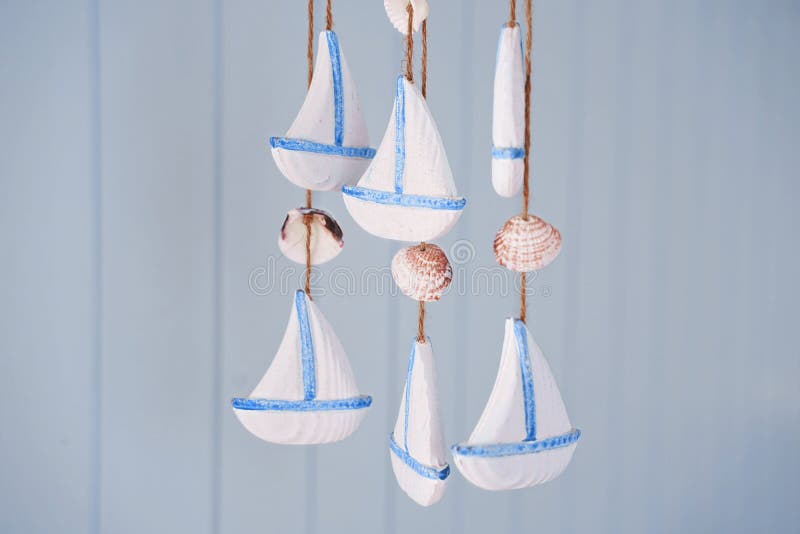 Seashells and Sailboat Hanging on Strings for Decoration. Stock Image ...