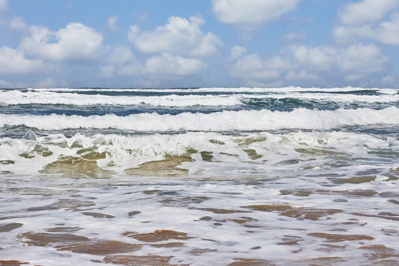 Seashore with Rolling Waves Against the Background of a Sky with Clouds ...