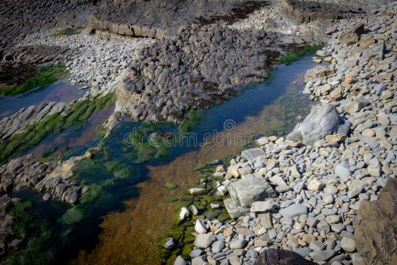 Rocky Pools by the Sea with Three Pool Ladders Stock Photo - Image of ...
