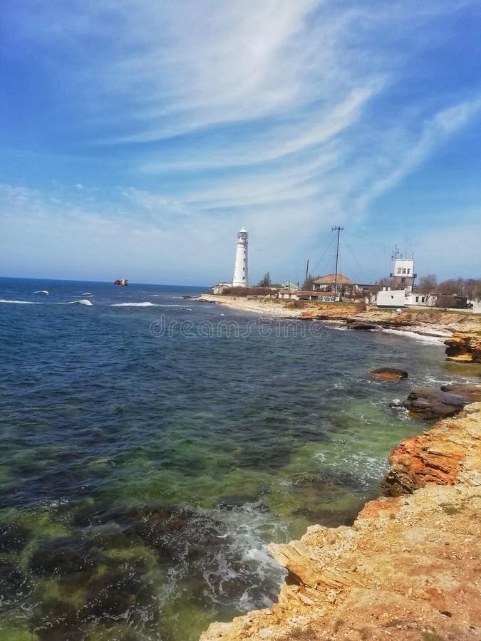 Seaside and Lighthouse View Stock Photo - Image of beach, breakwater ...