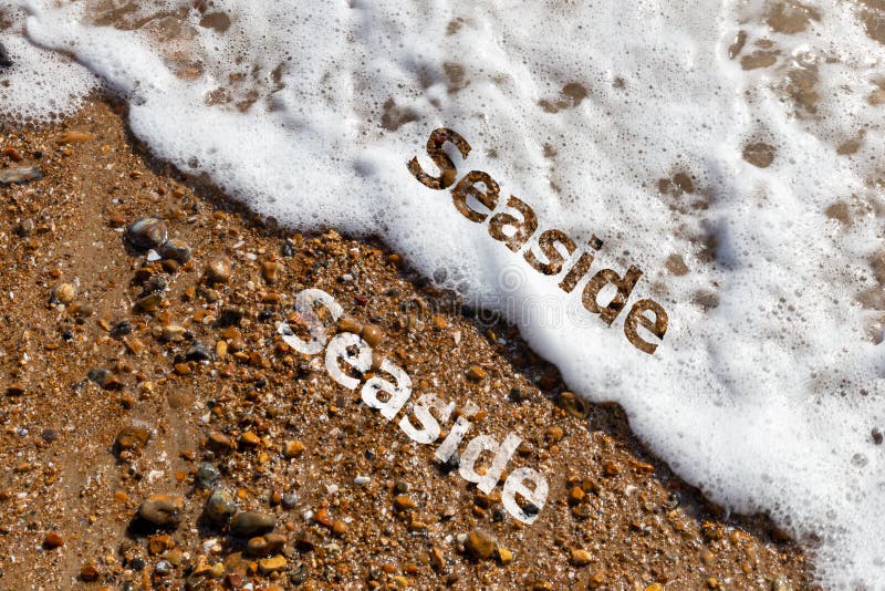 Seaside Text Cut Out on Pebble Beach and Lapping Waves Stock Image ...