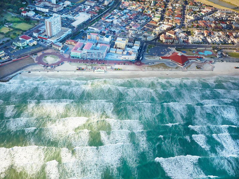Seaside Town. Aerial Shot of Ocean Waves and a Small Seaside Town ...