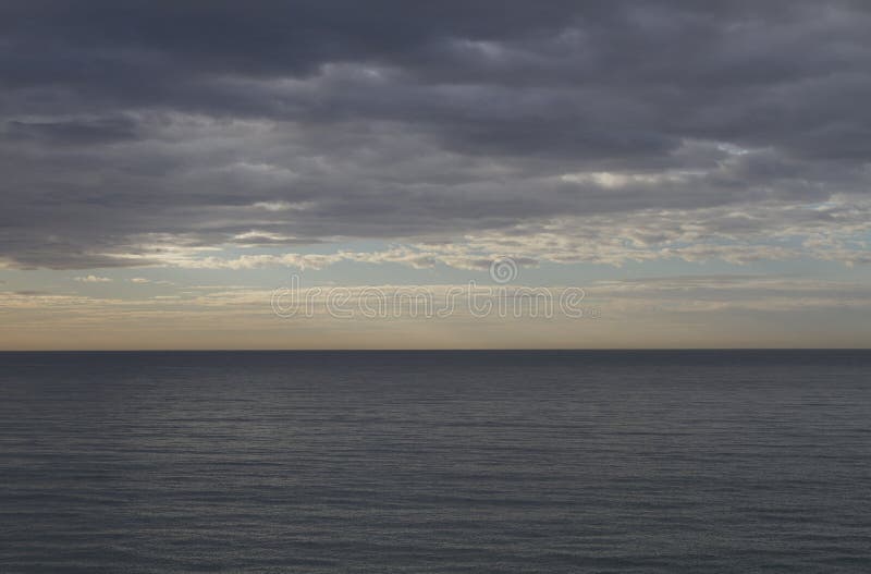 The Seascape View with Clouds Covering the Sun and a Smooth Calm ...