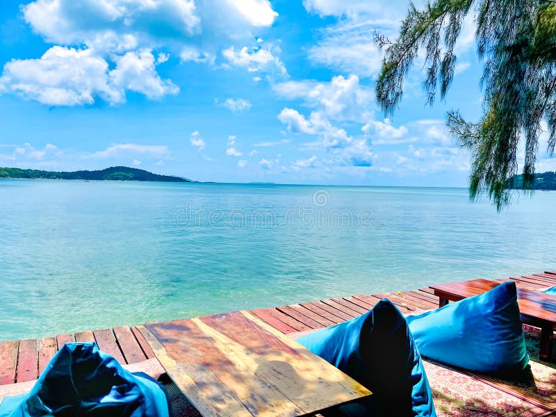 A Seaside View from a Cozy Wooden Setting Stock Photo - Image of table ...