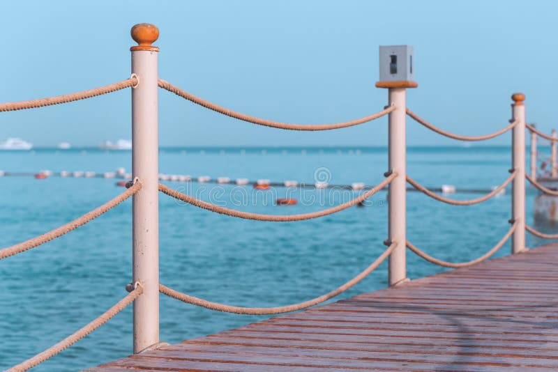 Seaside Wooden Pier with Posts and Ropes Stock Image - Image of ...