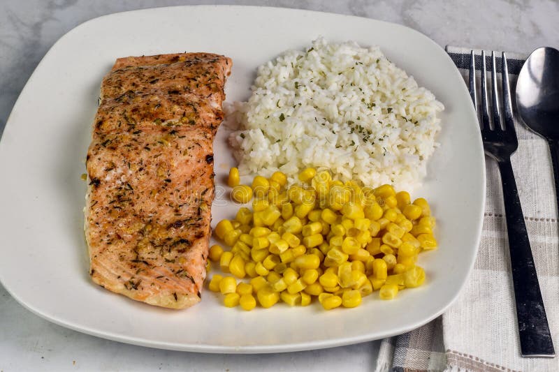 Seasoned Salmon Served with Corn and Rice Stock Image - Image of meal ...