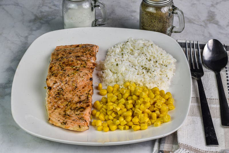 Seasoned Salmon Served with Corn and Rice Stock Photo - Image of baked ...