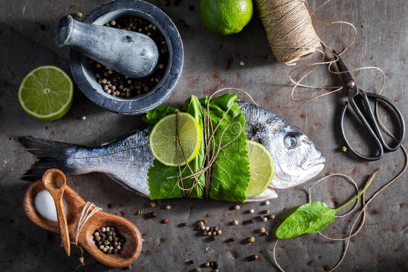 Seasoning Whole Fish with Salt and Pepper on Metal Table Stock Photo ...