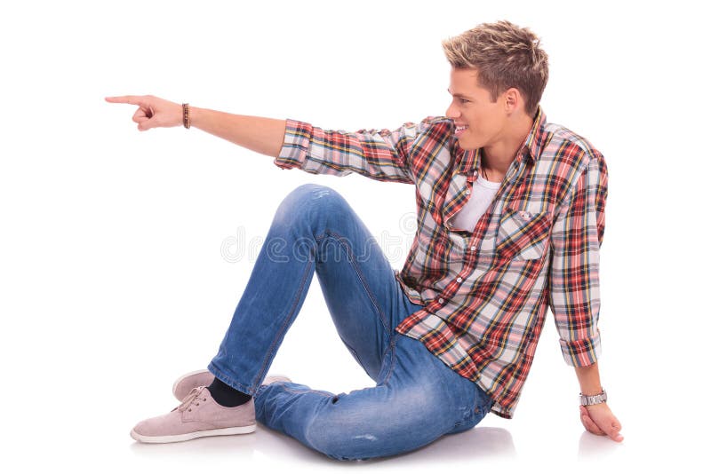 Seated Man Pointing To Side Stock Photo - Image of seated, attractive ...