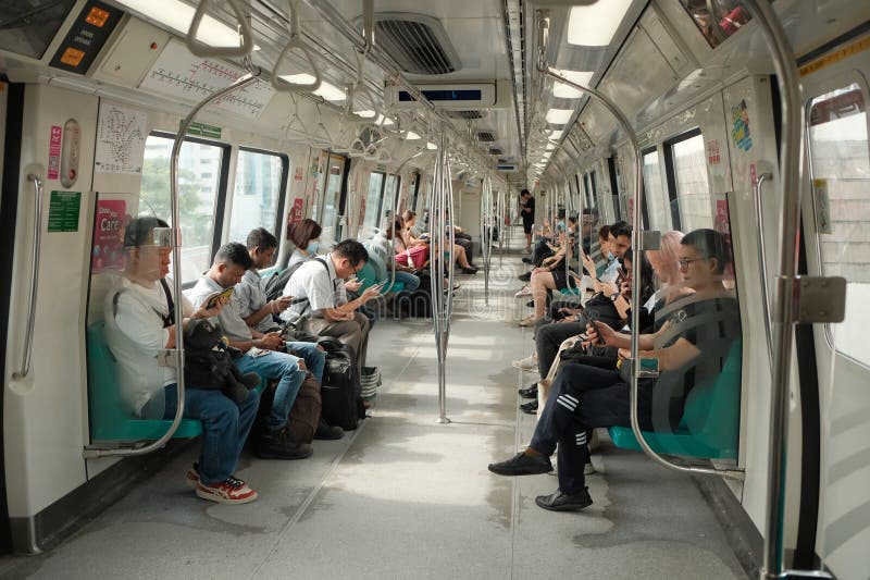 Seated Passengers Using Their Mobile Devices while Travelling on Public ...
