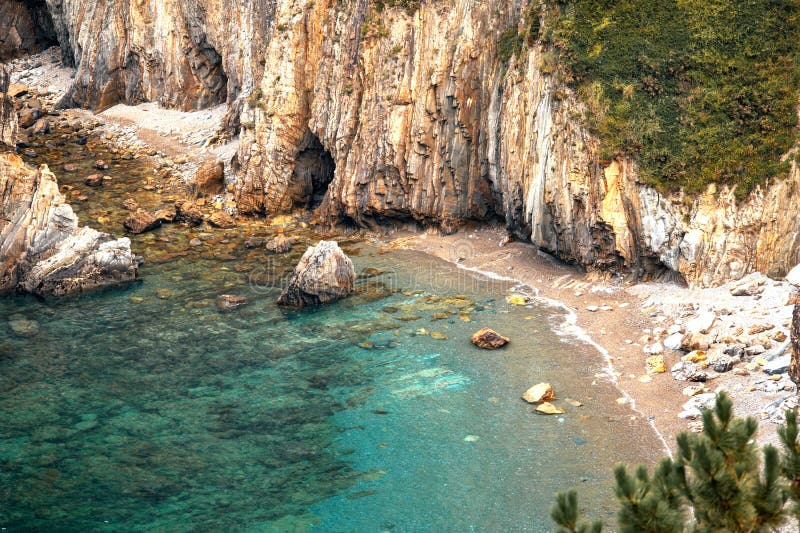 Secluded Beach with Crystal Clear Water and Rocky Cliffs Stock Image ...