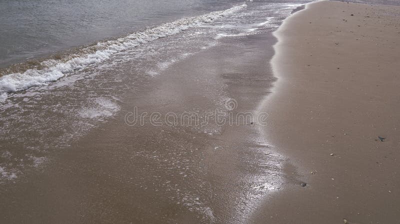 A Secluded Brown Sand Beach with Gentle Waves Stock Image - Image of ...