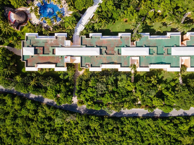 Secluded Resort with a Circular Pool, Surrounded by Palm Trees and a ...