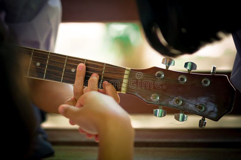 Secondary School Students are Learning How To Play Guitar in Sch Stock ...