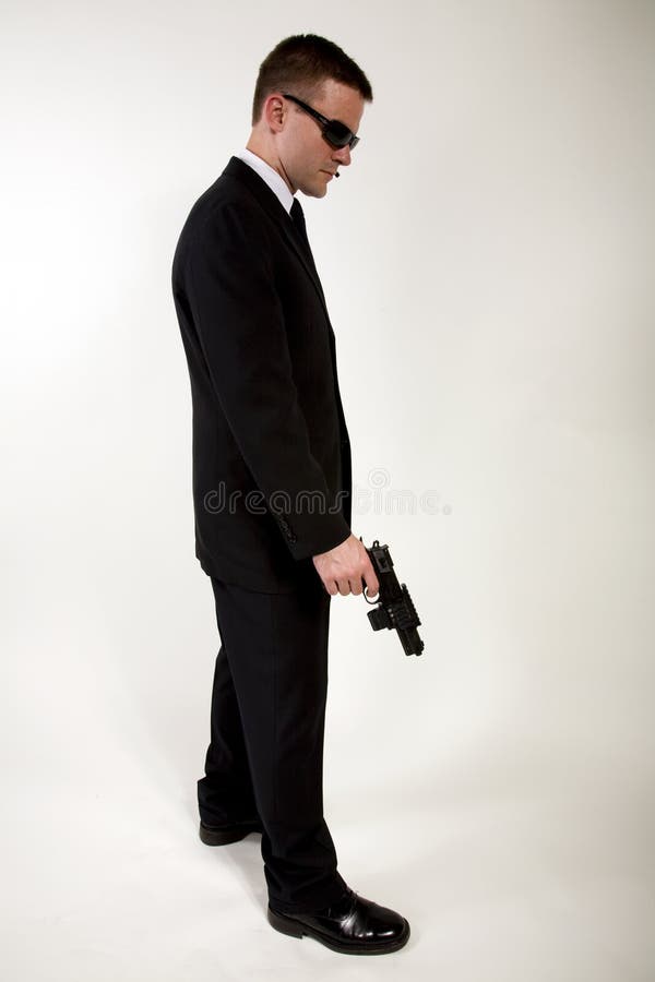 Secret Agent Reaches for Gun Stock Photo - Image of fashion, agent: 6795204