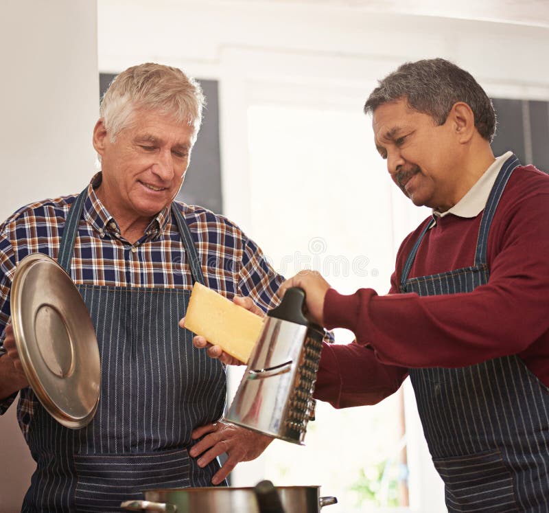 The Secret Ingredient is always Cheese. Two Senior Men Cooking in the ...