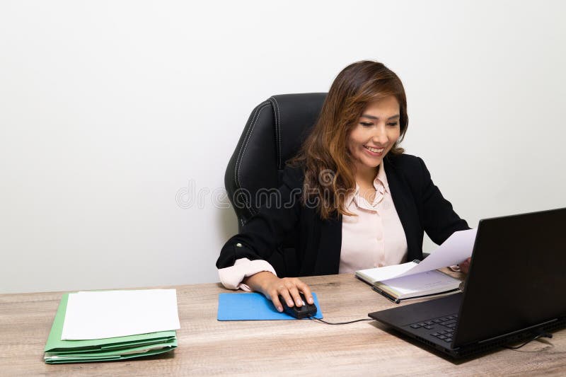 Secretary in Her Office Sitting Reading Papers in Front of Her Computer ...