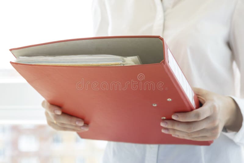 The Secretary is Holding a Red Folder. Stock Image - Image of ...